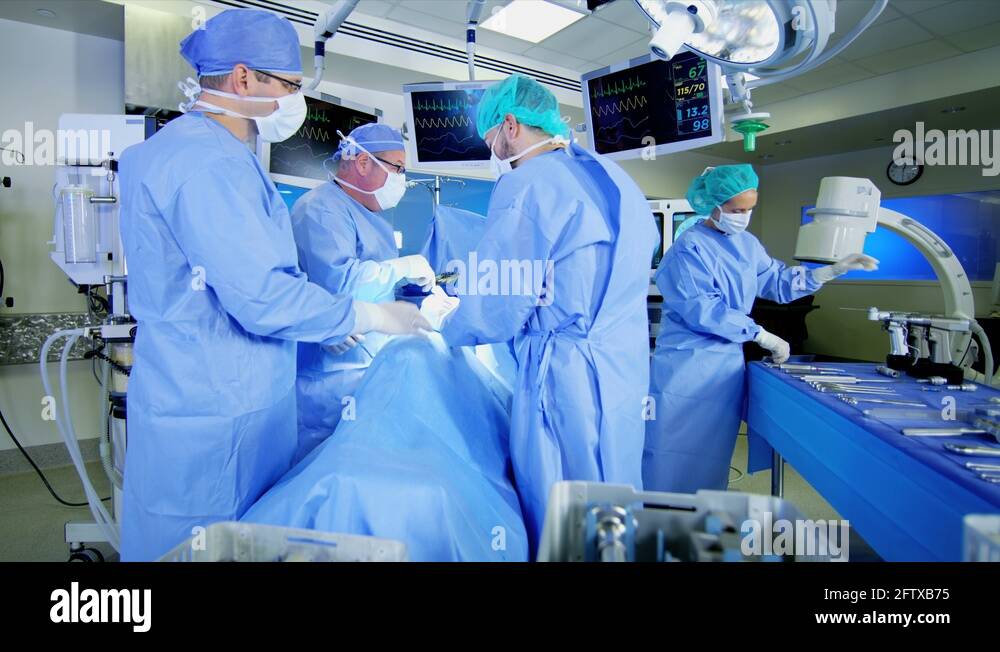 Orthopedic surgical operation performed on patient by male and female ...