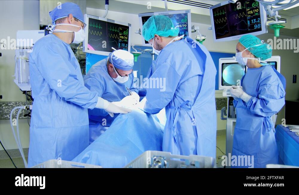 Orthopedic surgical operation performed on patient by male and female ...