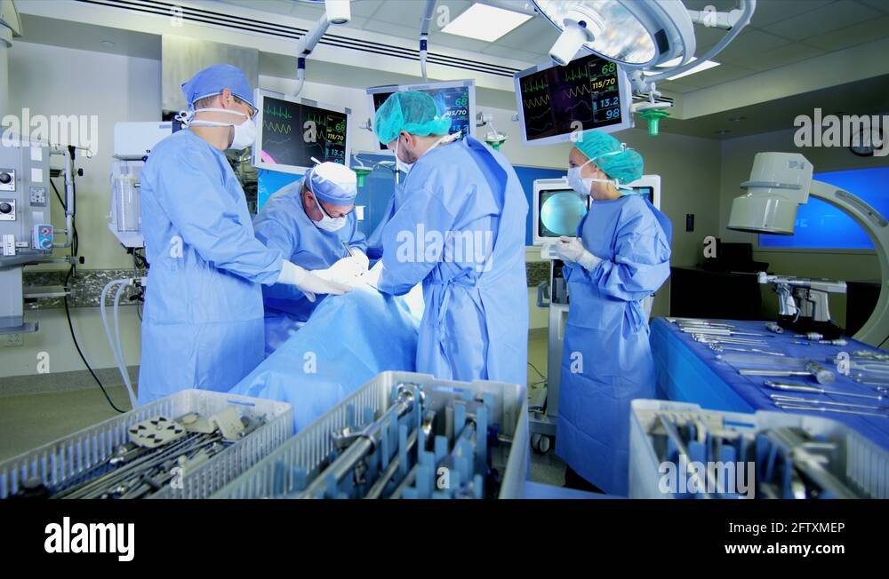 Orthopedic surgical operation performed on patient by male and female ...