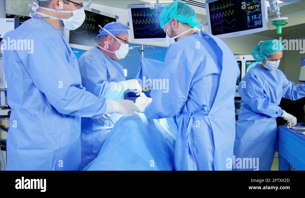 Orthopedic surgical operation performed on patient by male and female ...