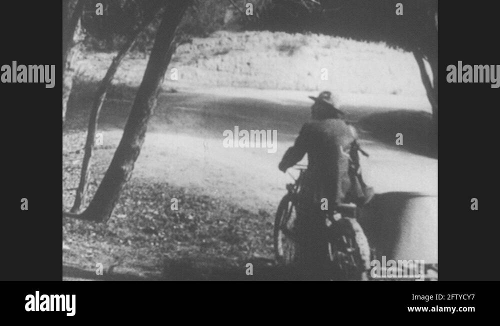 1910s: man rides and dismounts motorcycle with sidecar. man with ...