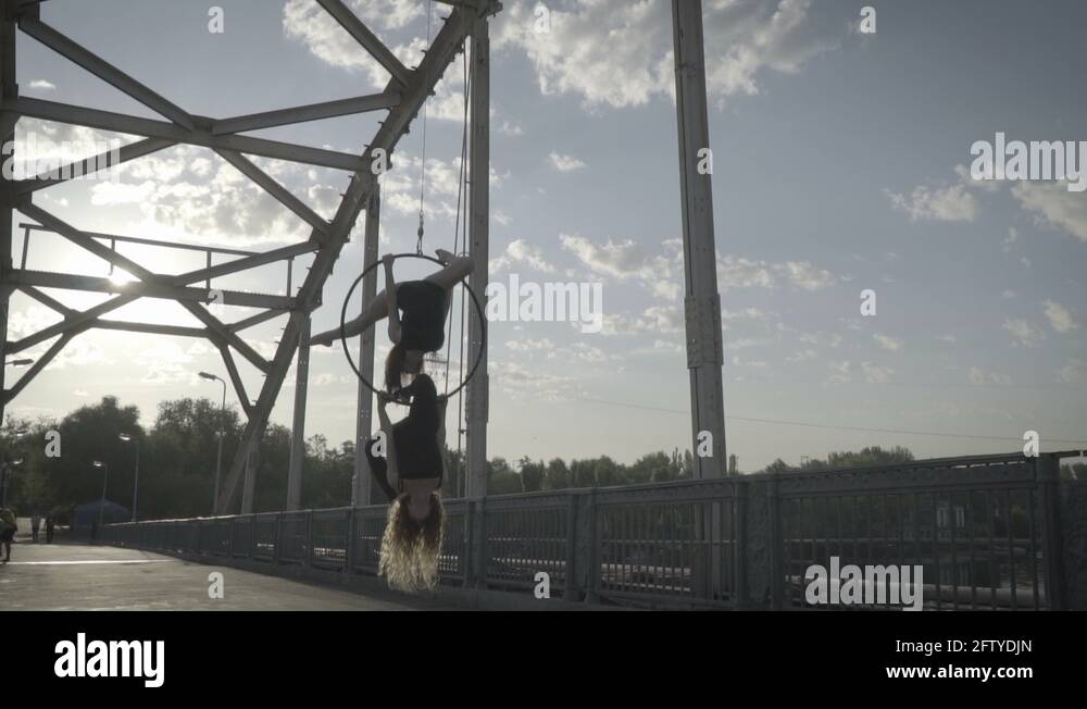 Two women in spectacular poses hang on the ring for aerial acrobatics ...