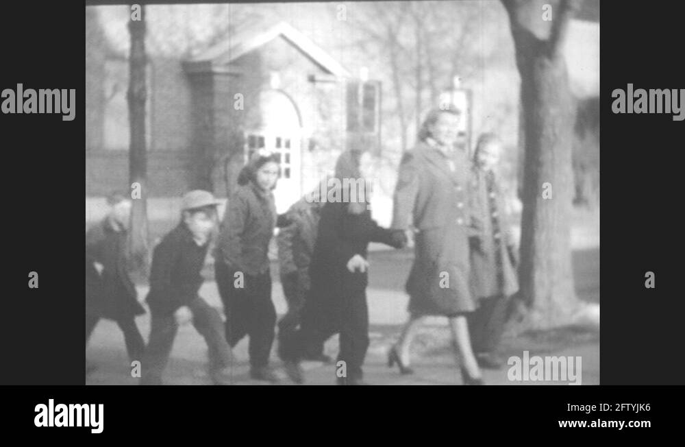 1940s: Woman shows children a Stop sign. Woman shows children a traffic ...