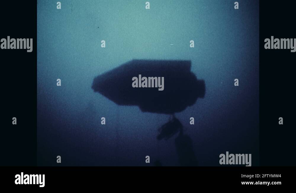 1970s: Underwater view, underside of diving station. Men on diving ...