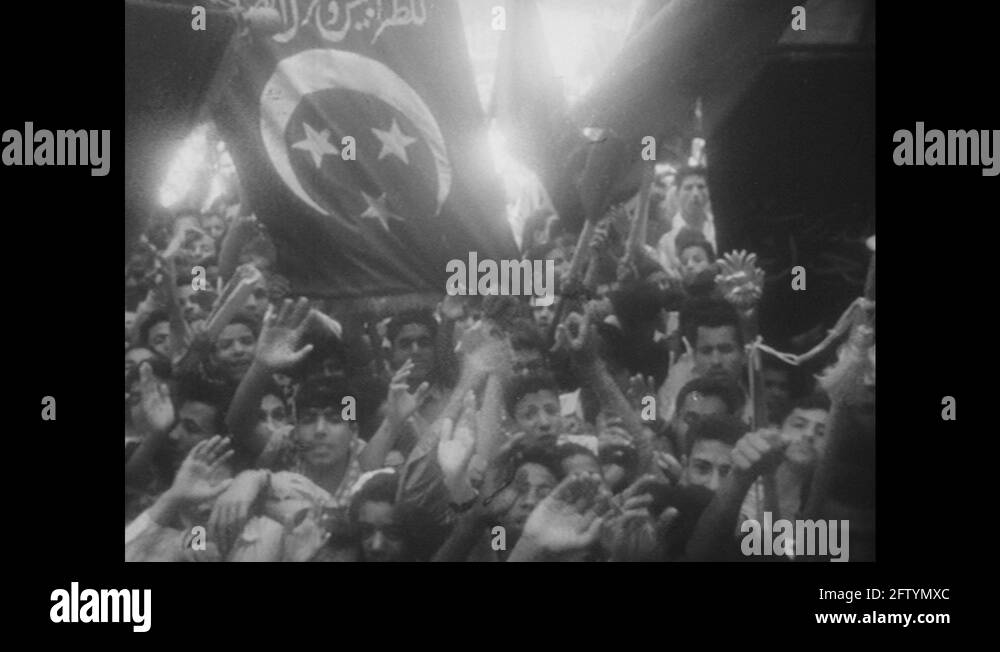 1960s: Crowd cheering. Man yelling in crowd. View of desert, fade out ...