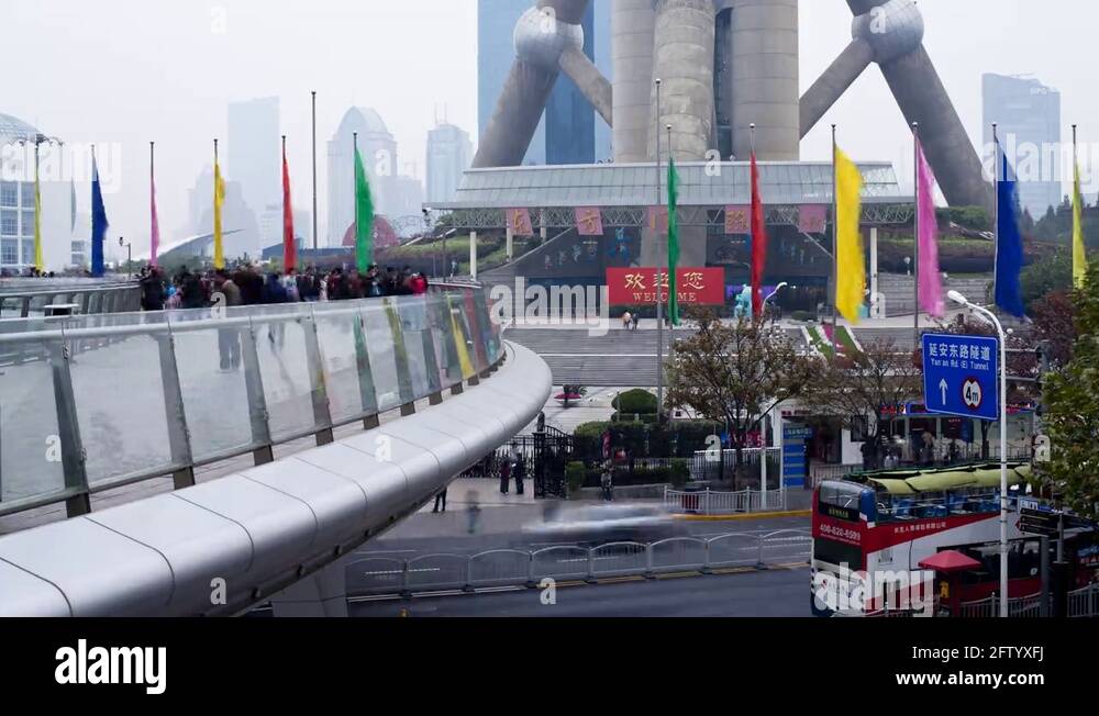 Circular pedestrian walkway with Flags flying above a traffic ...