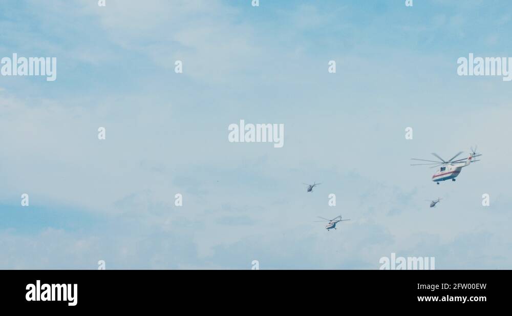 Formation of military fighter helicopters flying towards the horizon ...