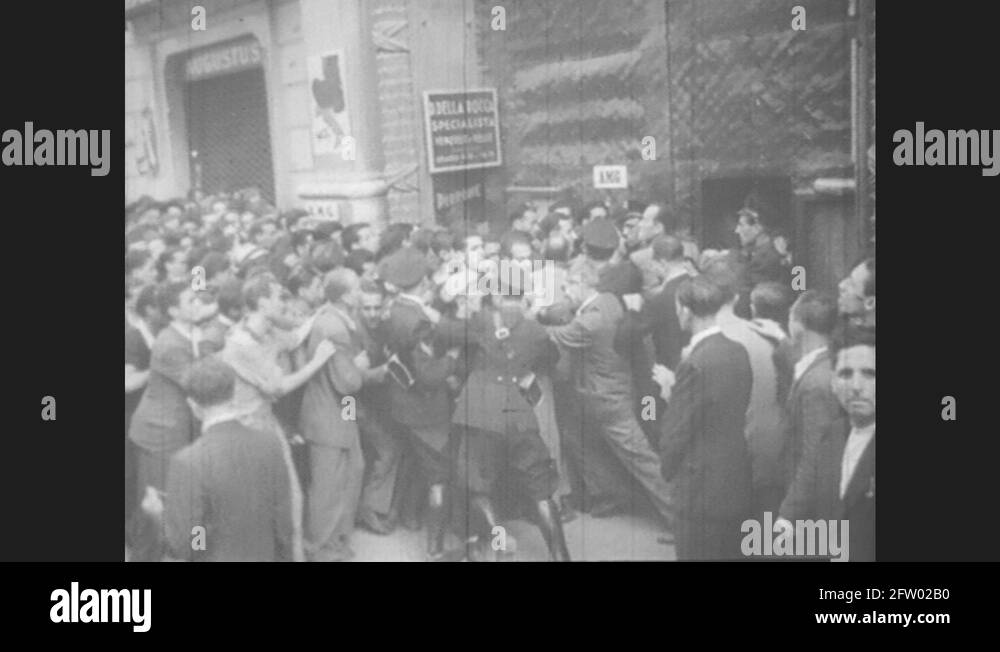 Europe 1940s: crowds push through lines. Angry people. Man fights ...