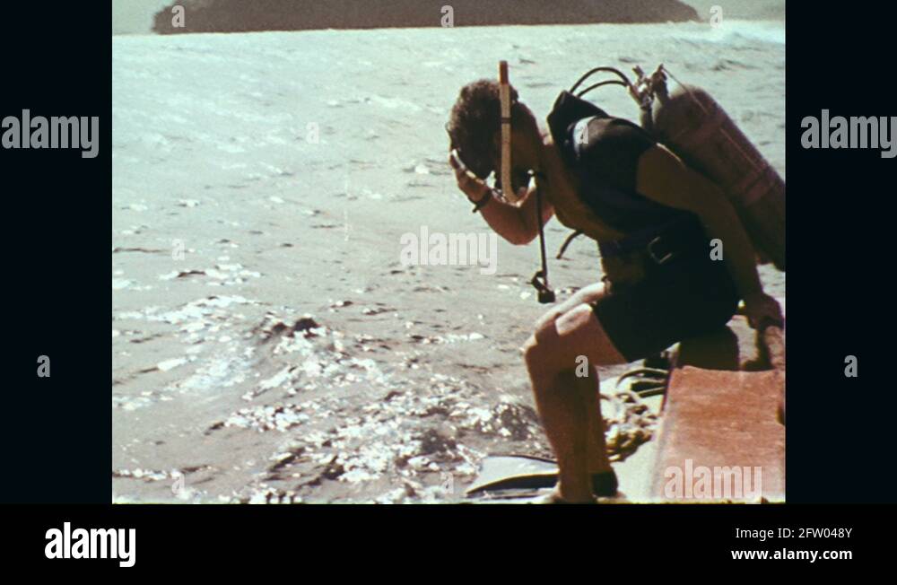 1970s: Diver jumps from boat. Diver underwater. Diver jumps from boat ...