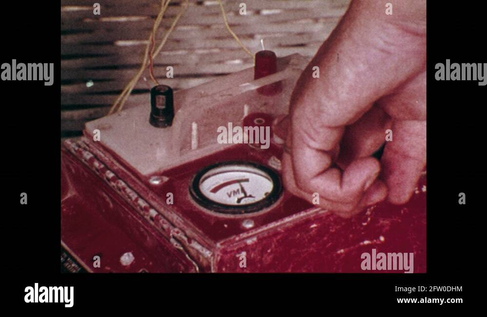 1970s: UNITED STATES: hand presses button on detonator. Explosion in ...