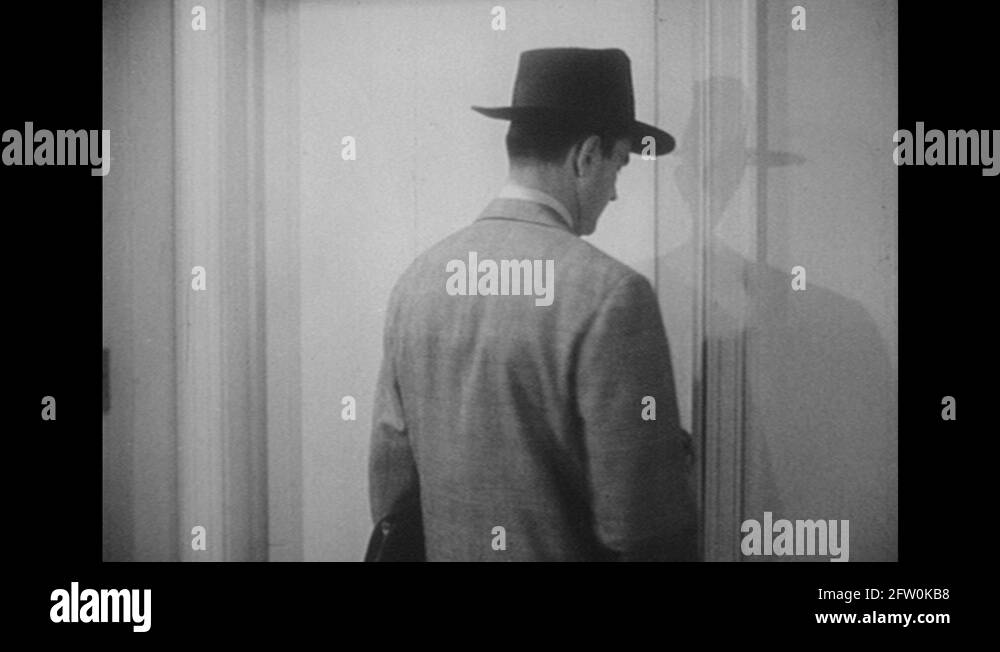 1950s: Husband locks door. Man tosses keys and puts them in his pocket ...