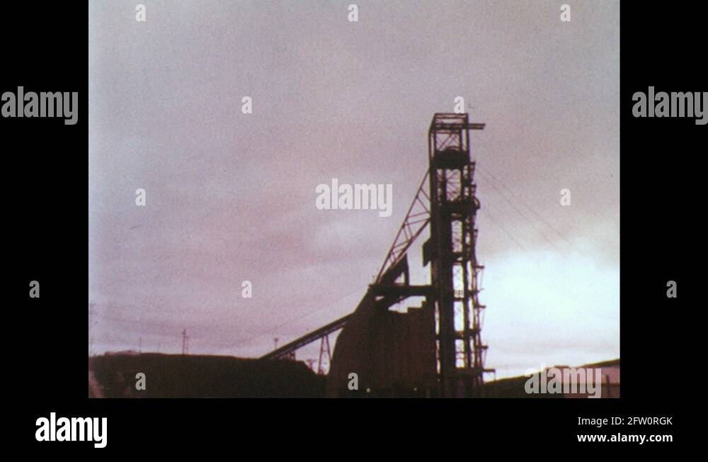1970s: Exterior view of mine site with scaffold. Inside the mine, a ...
