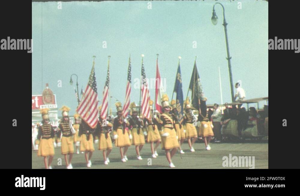 1940s: Marching band marches with flags. Band leader passes. Marching ...