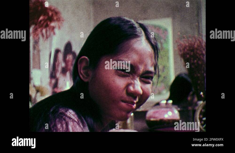 1970s: Girl smiling, shaking head, squints eyes briefly. Syrup on ...