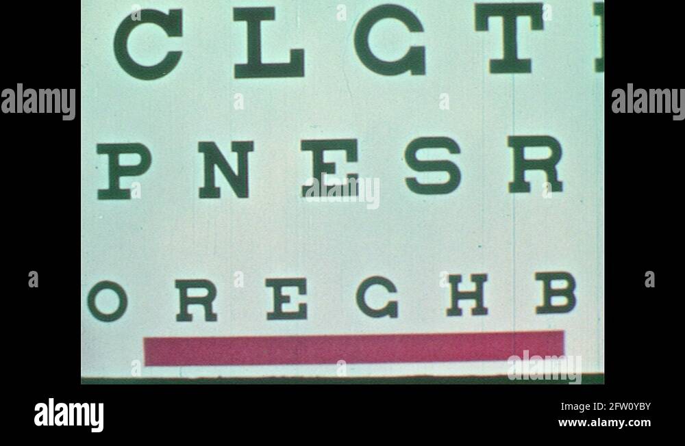 1950s: Eye test chart changing in and out of focus. Man with apron ...
