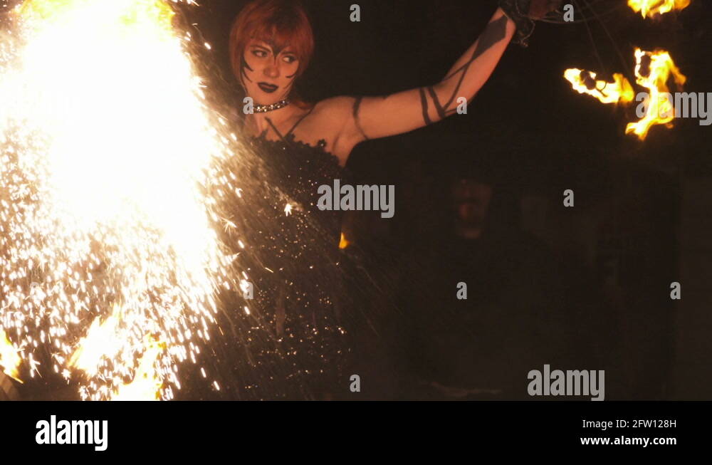 Fiery dance. Amazing magical Fire Show at night. Slow shutter speed ...