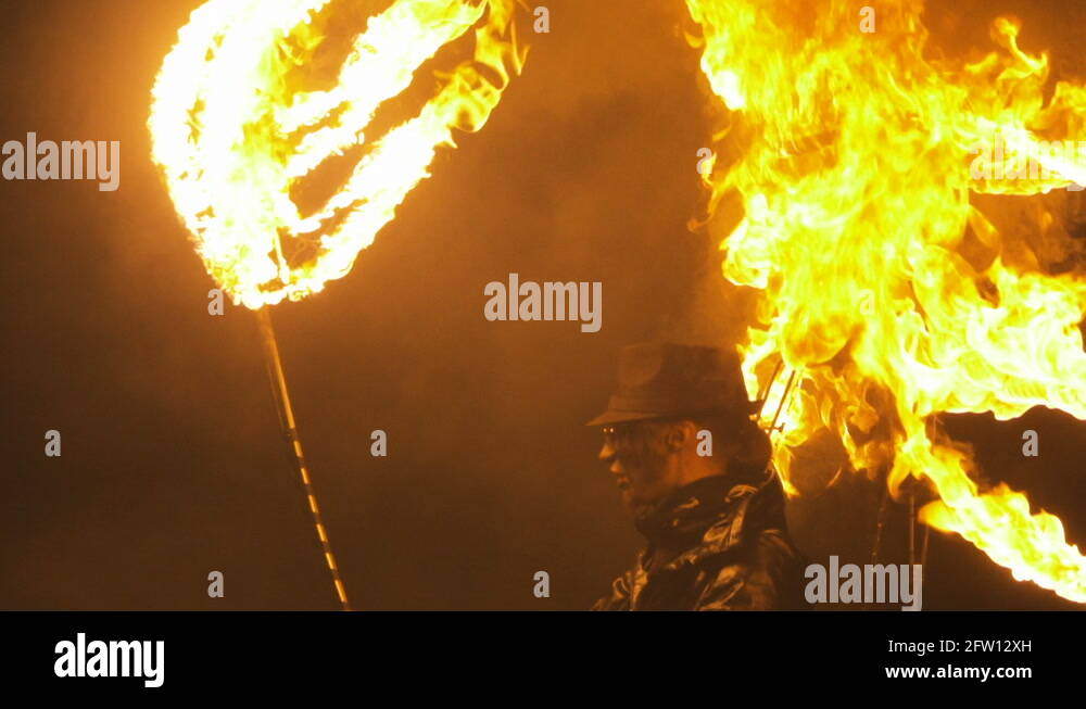 Fiery dance. Amazing magical Fire Show at night. Slow shutter speed ...