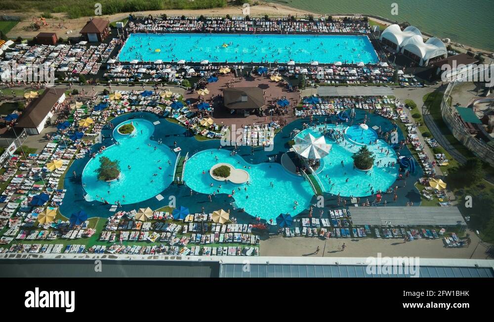 Sunny Hotel swimming pool - crowd of people rest and swim in resort ...