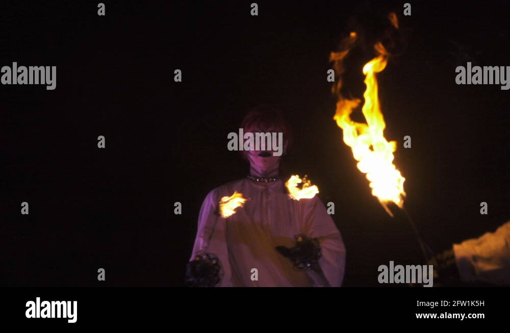 Fiery dance. Amazing magical Fire Show at night. Slow shutter speed ...