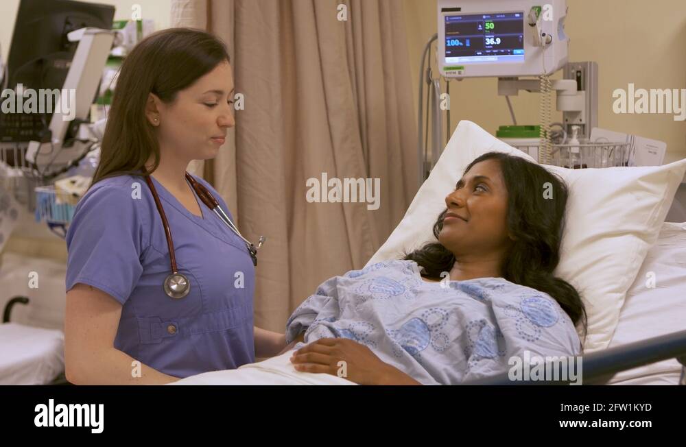 Nurse takes a patient's vitals, including blood pressure, pulse and ...