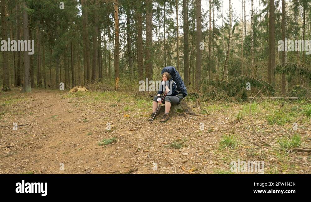 Beautiful girl sitting on a stump in a summer forest - flying camera ...