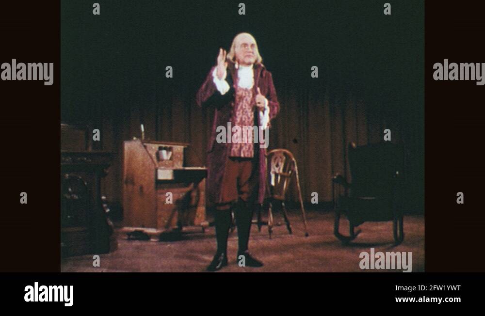 1970s: Benjamin Franklin speaks and gestures. Women in audience listen ...