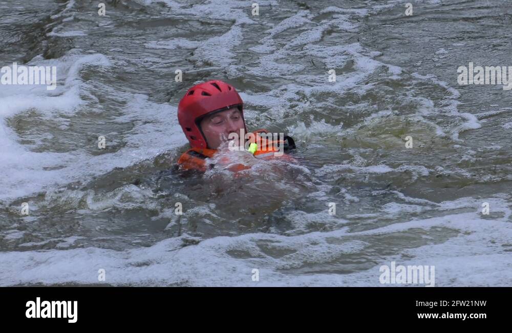 water rescue man floating down stream 4k Stock Video Footage - Alamy