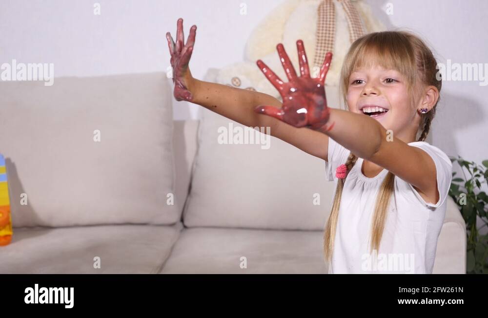 Little girl making hand-prints with paint Stock Video Footage - Alamy