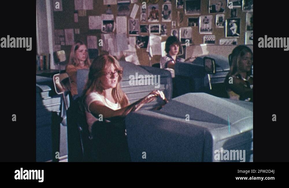 1970s: Students in classroom using driving simulators. Car in reverse ...