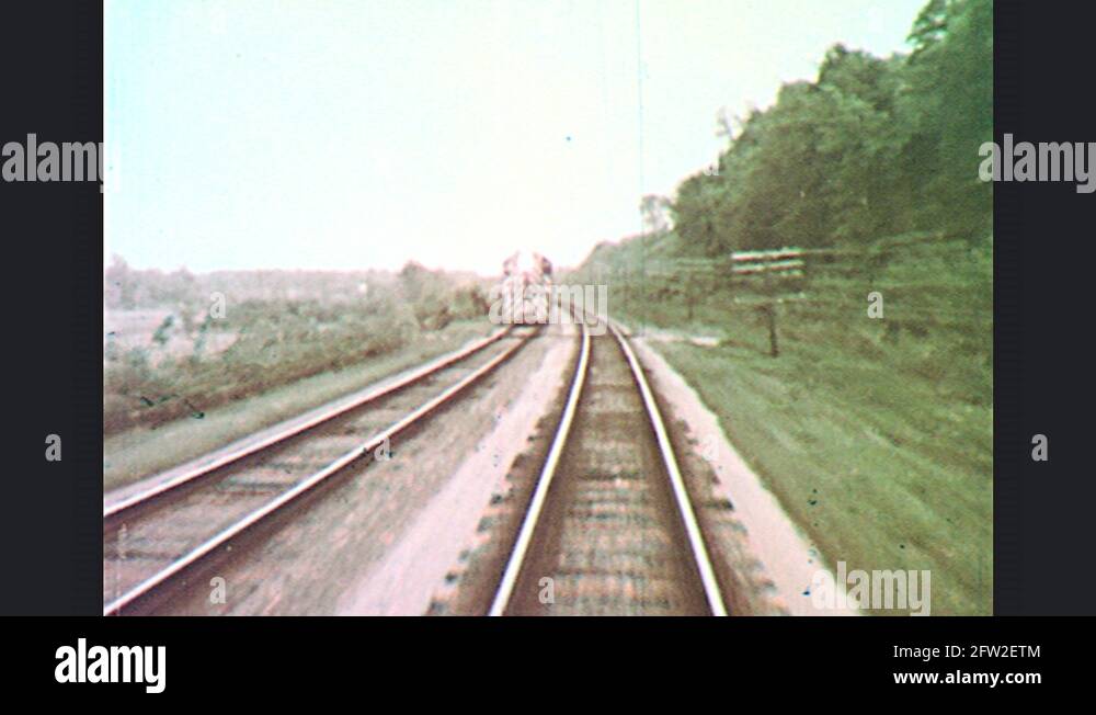 1950s: UNITED STATES: view of railway and freight train from train ...