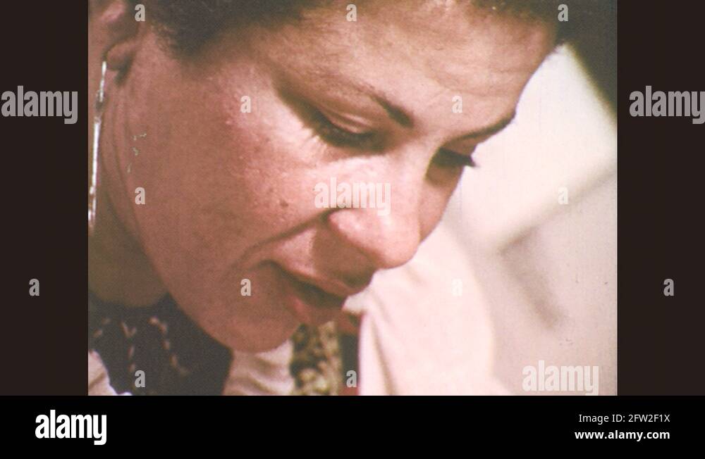 1970s: woman draws on paper at drafting table. woman shows woman with ...