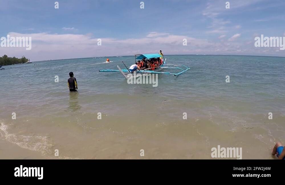 Passenger boat landing on sea shore Stock Video Footage - Alamy