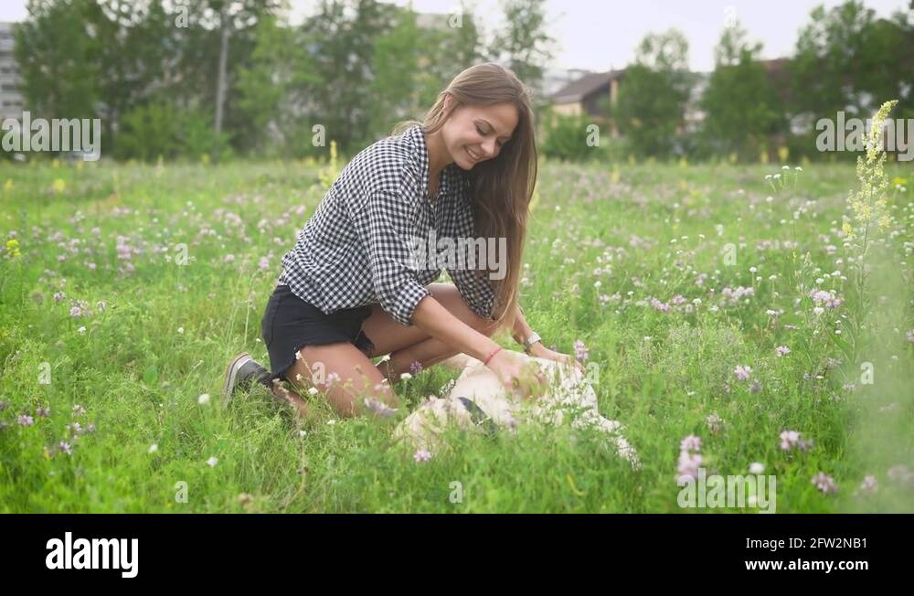 Attractive woman petting and cuddling her dog. Friendship loving bond ...