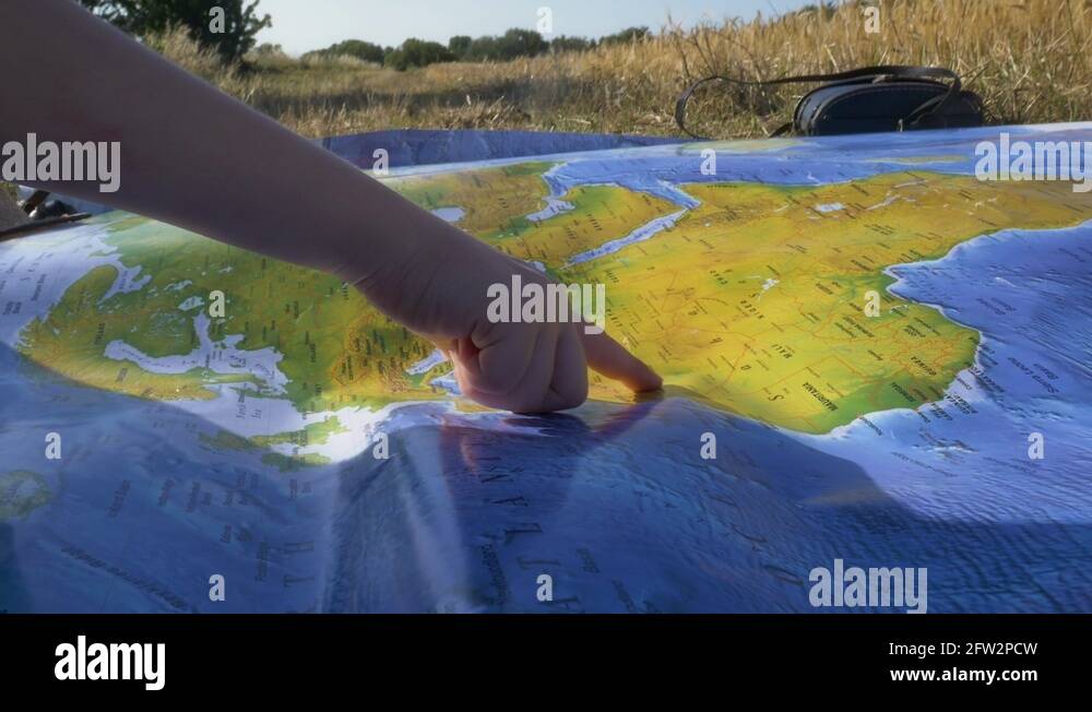 Little Girls pointing at World Map Lying on the Ground Outside Stock ...