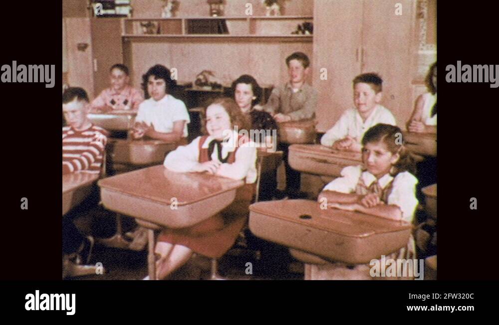 1950s: Classroom full of students nodding. Circle of students surround ...