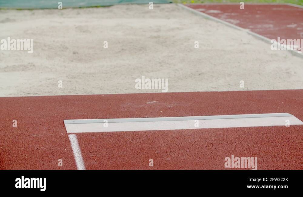 When a student performs a long jump, he lands on his feet and hands ...
