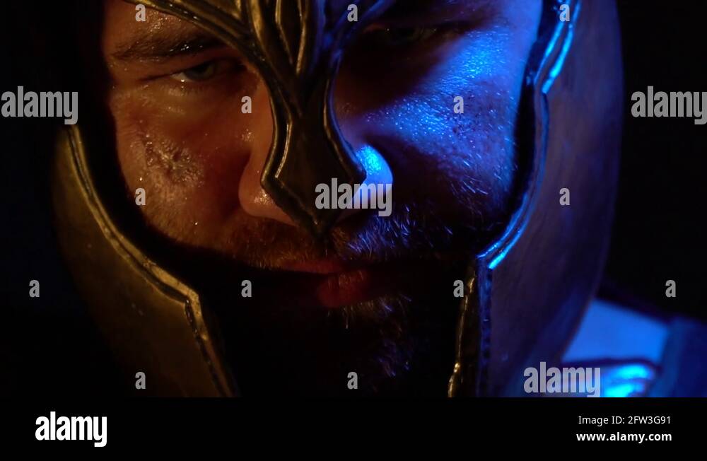 Bald Roman gladiator with a beard and scar in his face puts off a ...