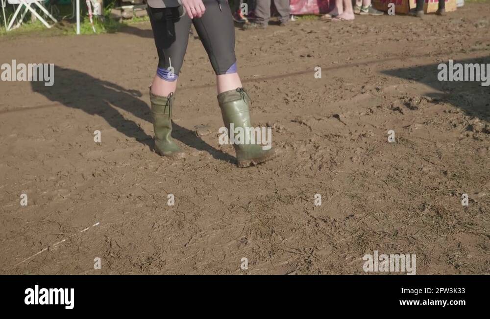Woman's legs in rubber boots and sport leggins walking on mud after ...