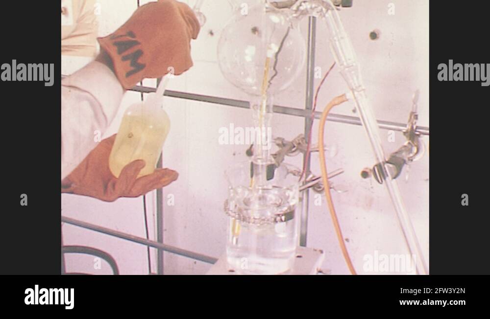 1960s: Laboratory experiment. Two soldiers mount missile. Engineer ...
