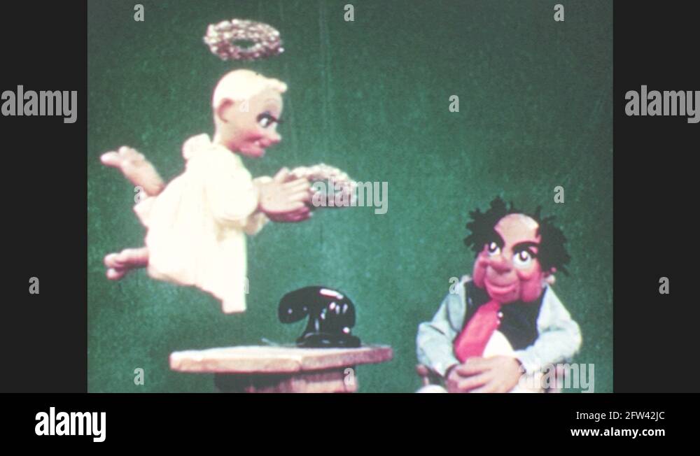 1950s: Marionette angel puppet places halo on puppet man sitting at ...