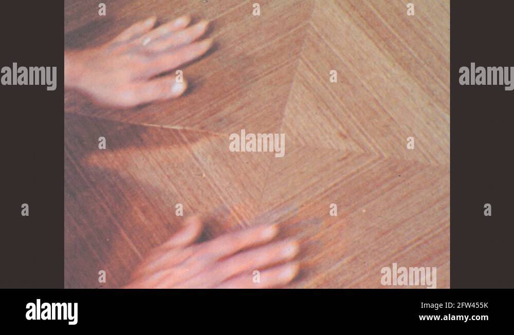 1970s: Hands match up diamond pattern of wood veneer. Wood veneer moves ...