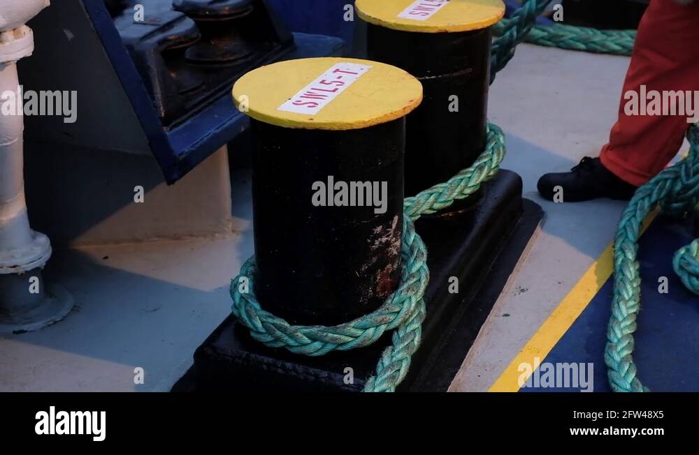 Sailor is wrapping the rope during mooring of the ship Stock Video ...