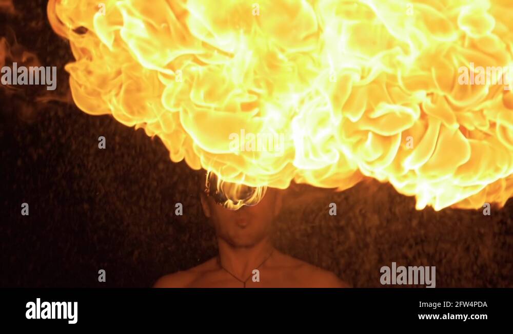 Man is spitting fire cloud. Flame eruption and burning from mouth. Fire ...