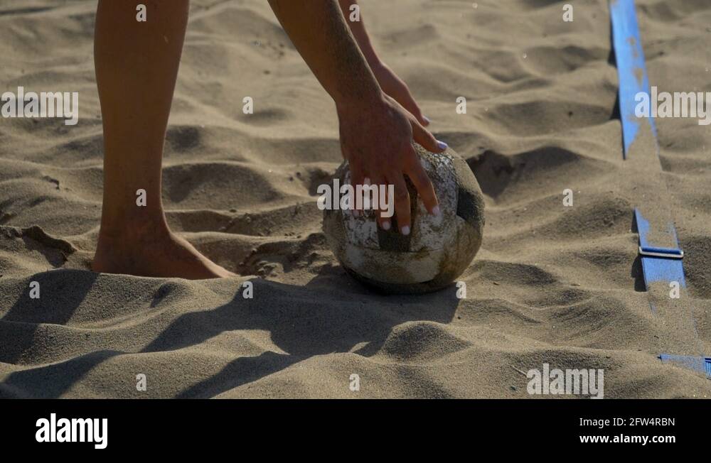 Women players play beach volleyball and a player serves the ball, super ...
