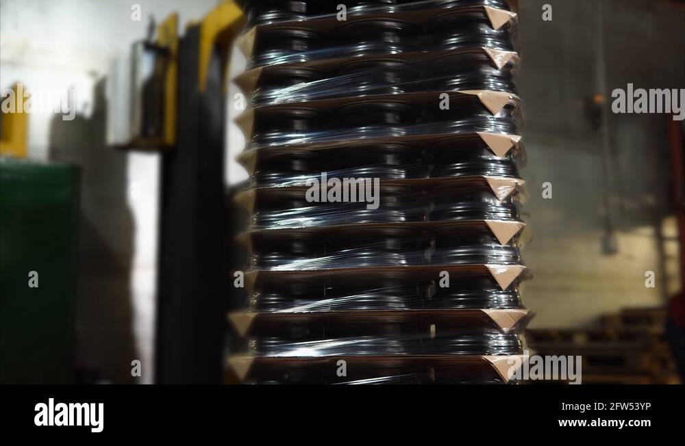 Stamped discs are placed on a shipping container wrapping on a packing ...