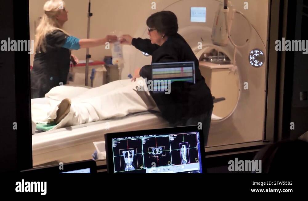 X-Ray staff prepare to remove patient from CT scanner following ...