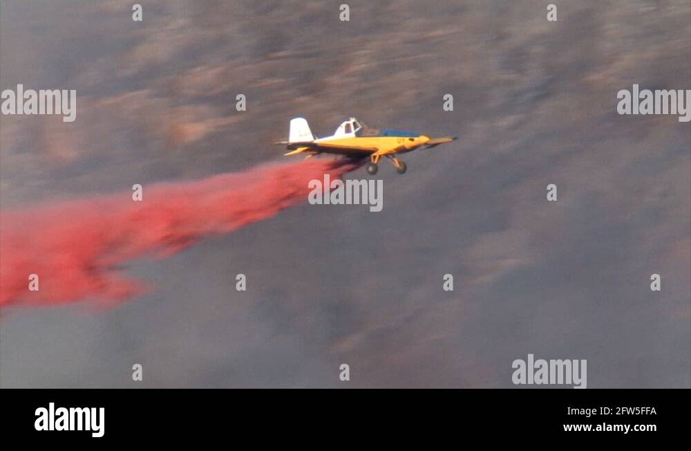 Fire fighting plane fly low and spray fire extinguisher on forest Stock ...