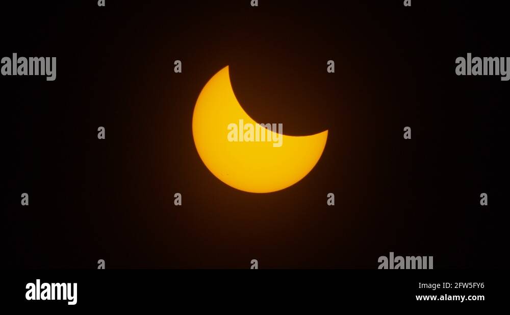 Moon moving across the sun during the solar eclipse as seen in the path ...