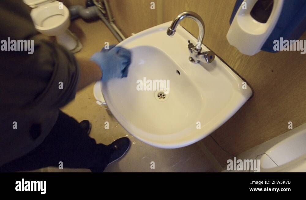 cleaning hand wash basin in a public restroom Stock Video Footage - Alamy