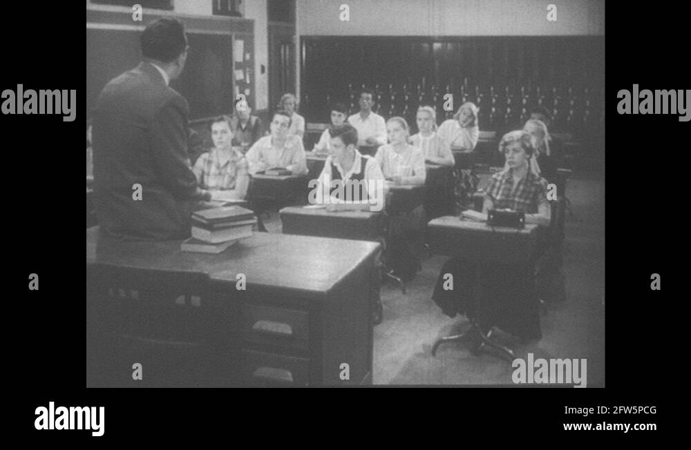 1950s: Teacher talking to class. Views of students in classroom Stock ...